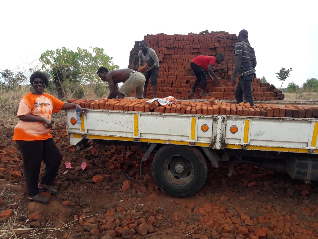 Helping to load Bricks | Dayspring Missions of Hope Inc